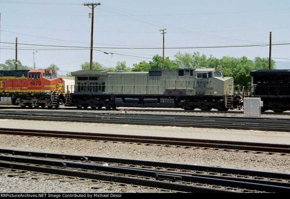"Ahh, The Primer Years" NS C40-9W #9909 is the second unit on a BNSF eastbound, entering the ...